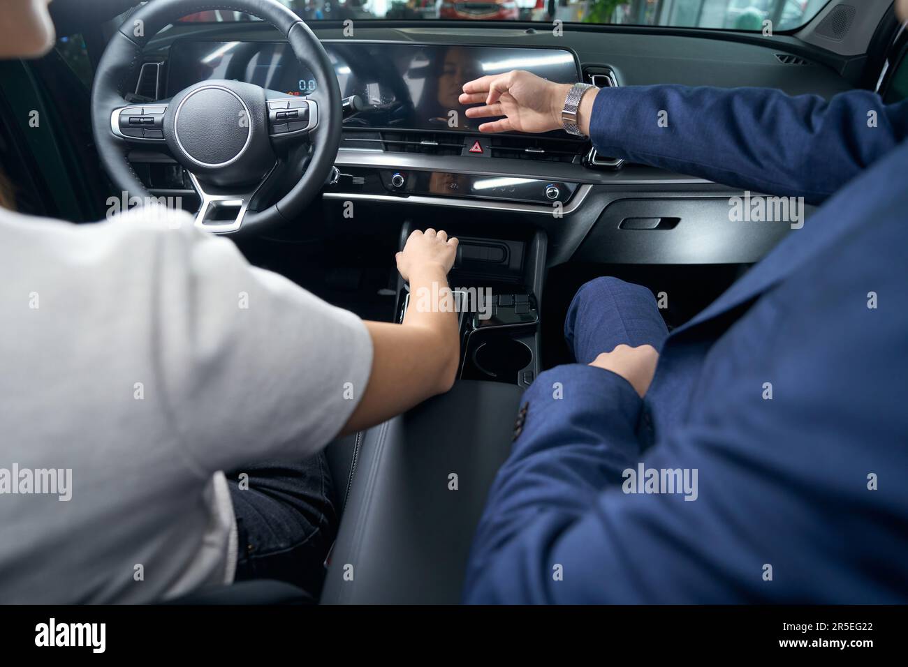Car dealership manager helps a client choose a car Stock Photo - Alamy
