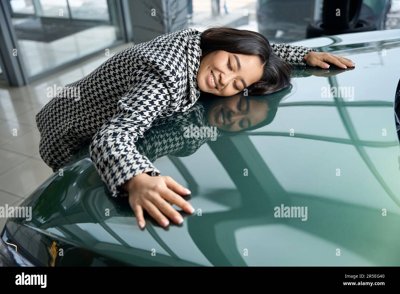 Beautiful young asian woman hugging the hood of shiny car Stock Photo ...