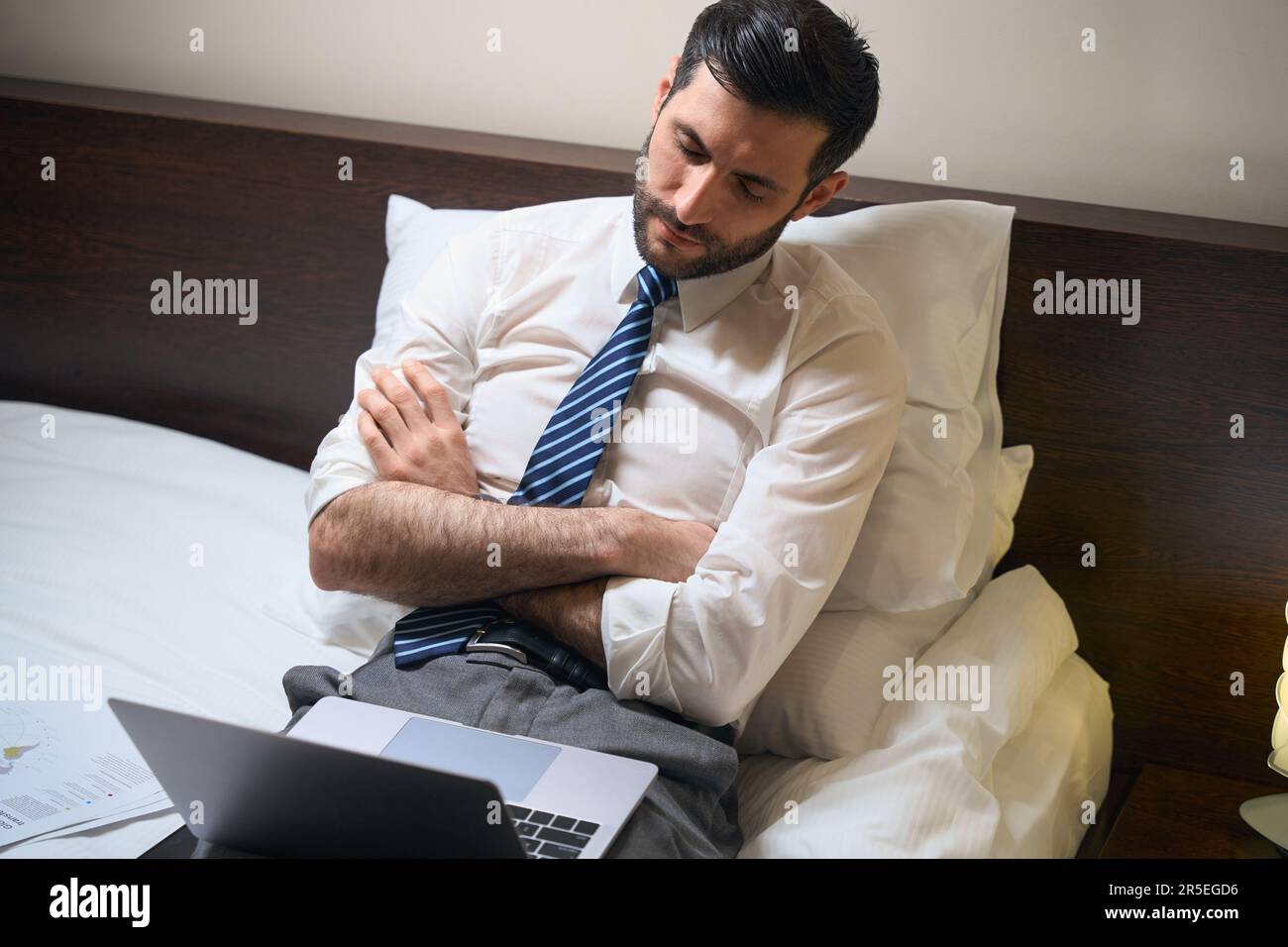 Tired man in office clothes fell asleep while working on documents ...