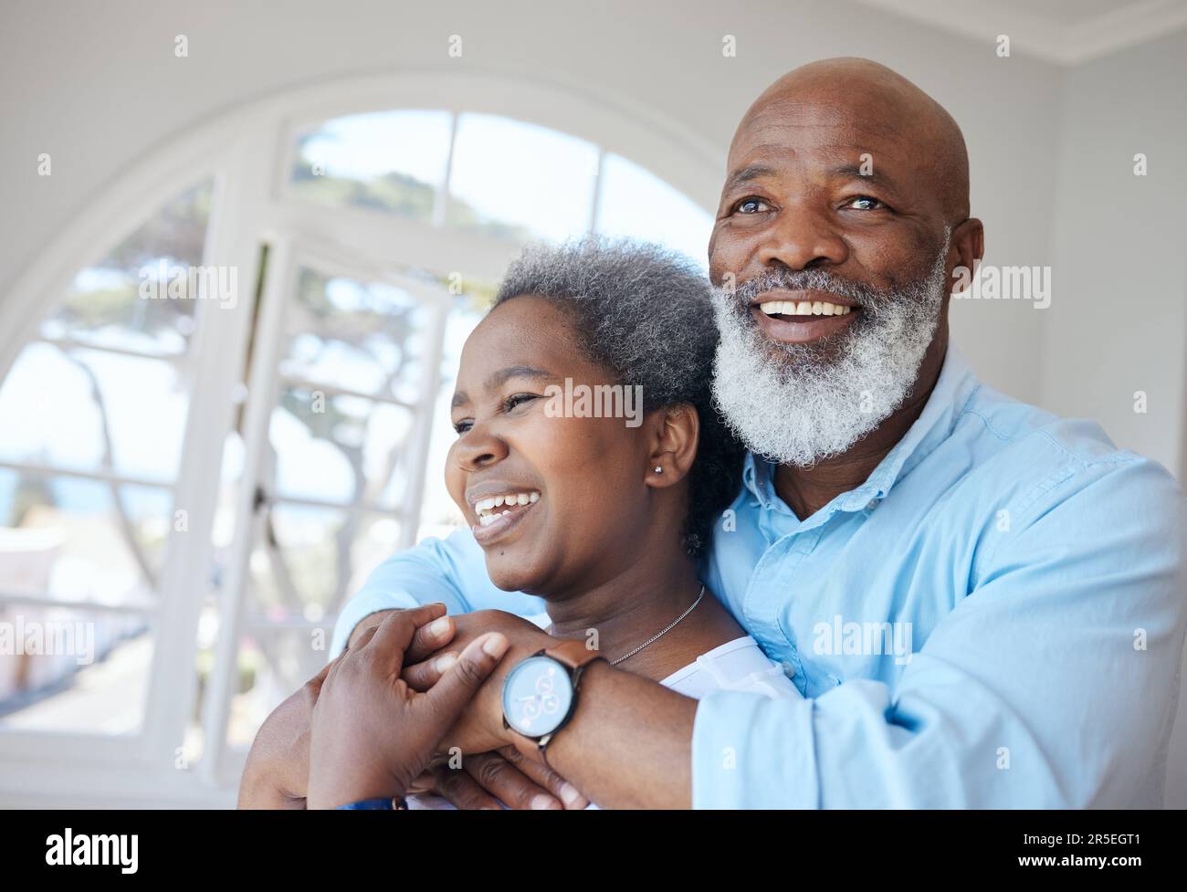 Senior black couple, hug and together in a home with love, care and ...