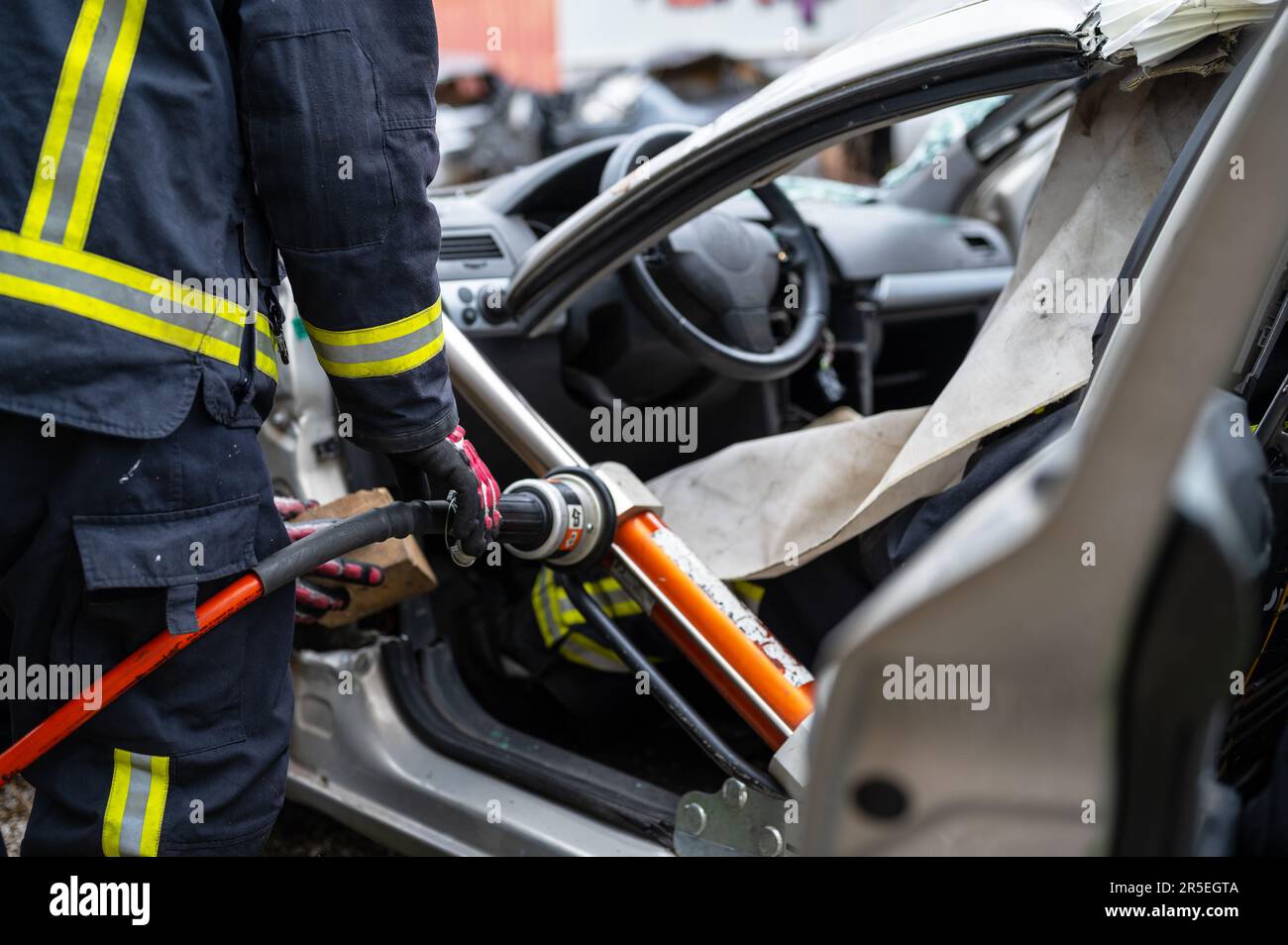 Firefighters using hydraulic tools during a rescue operation training ...