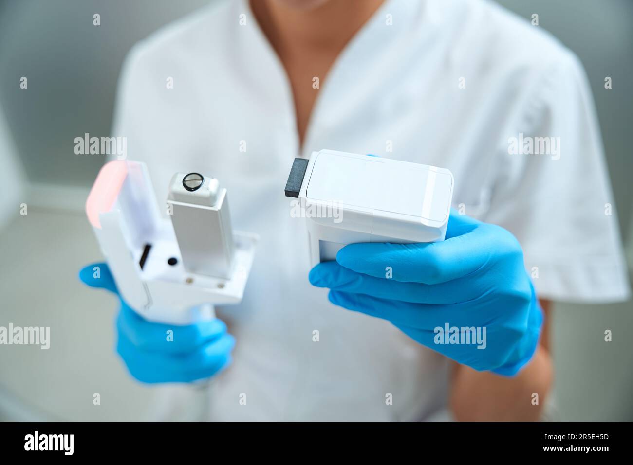 Female beautician holding a module of apparatus for smass lifting Stock ...