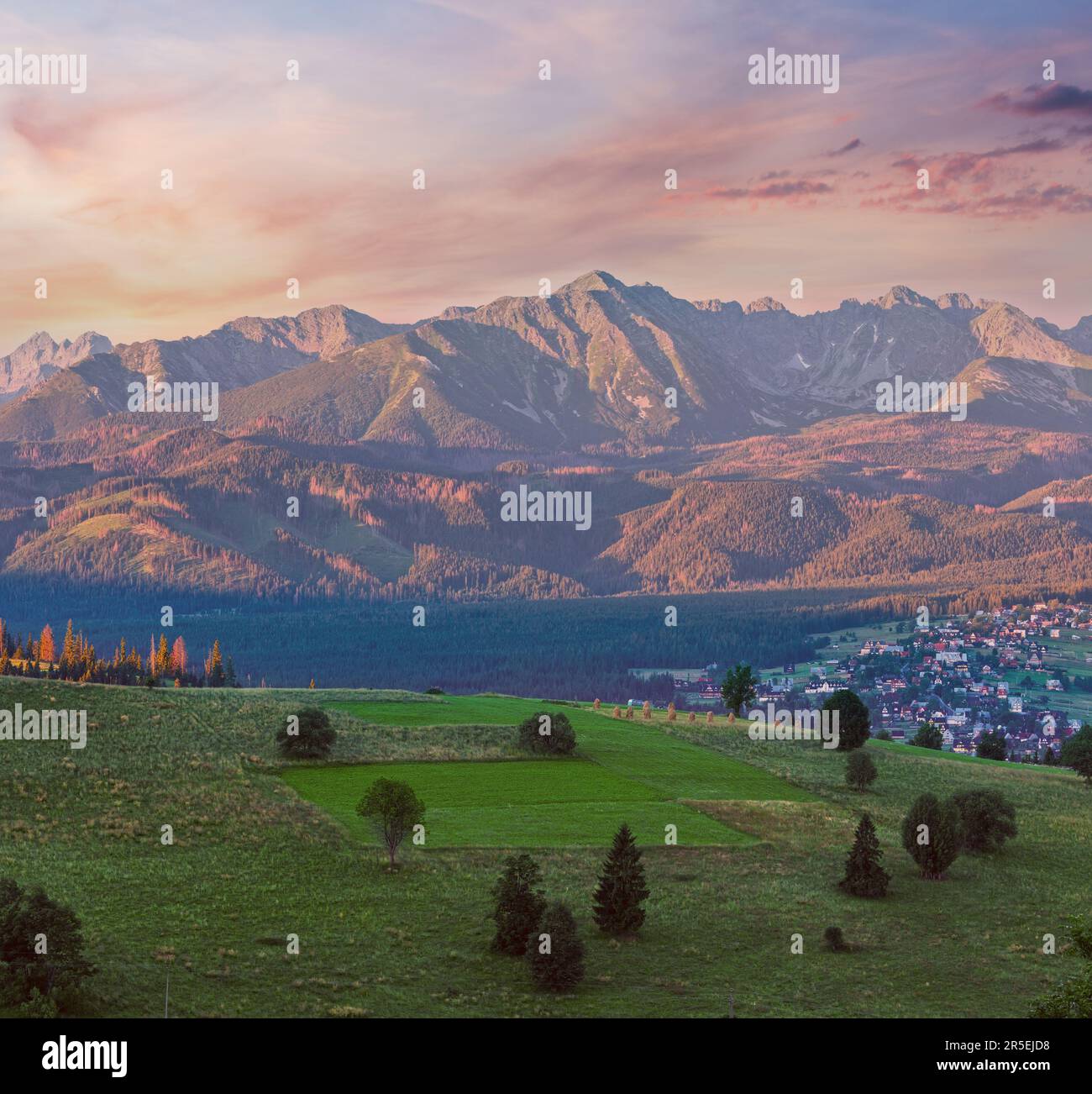 Summer sunrise mountain village outskirts view and Tatra range behind ...