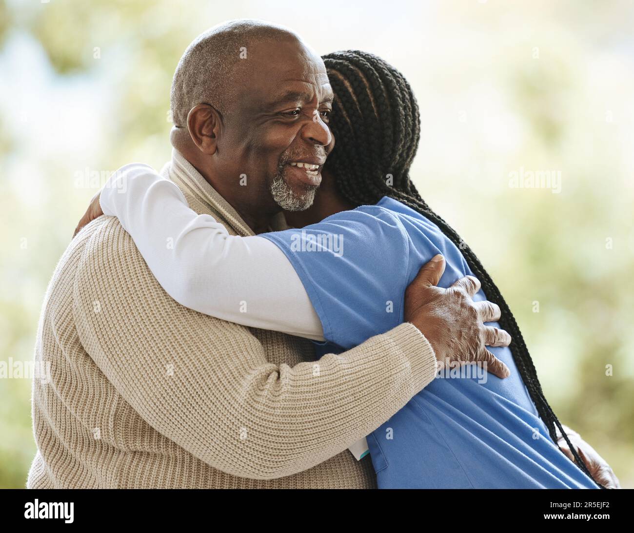 Senior man, caregiver and hug for support, healthcare and happiness at ...