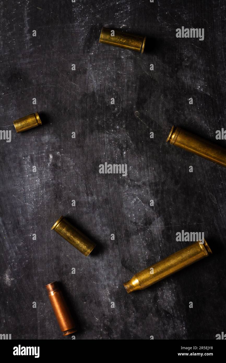 Empty bullet cartridges lying on the black background Stock Photo - Alamy