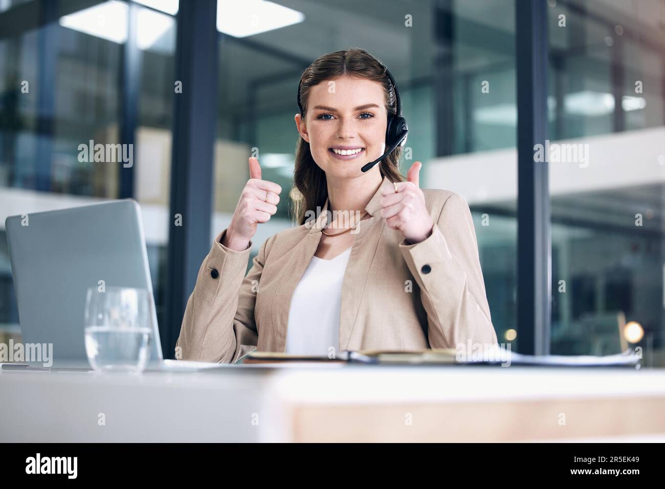 Thank you, portrait of call center agent with thumbs up and headset at ...
