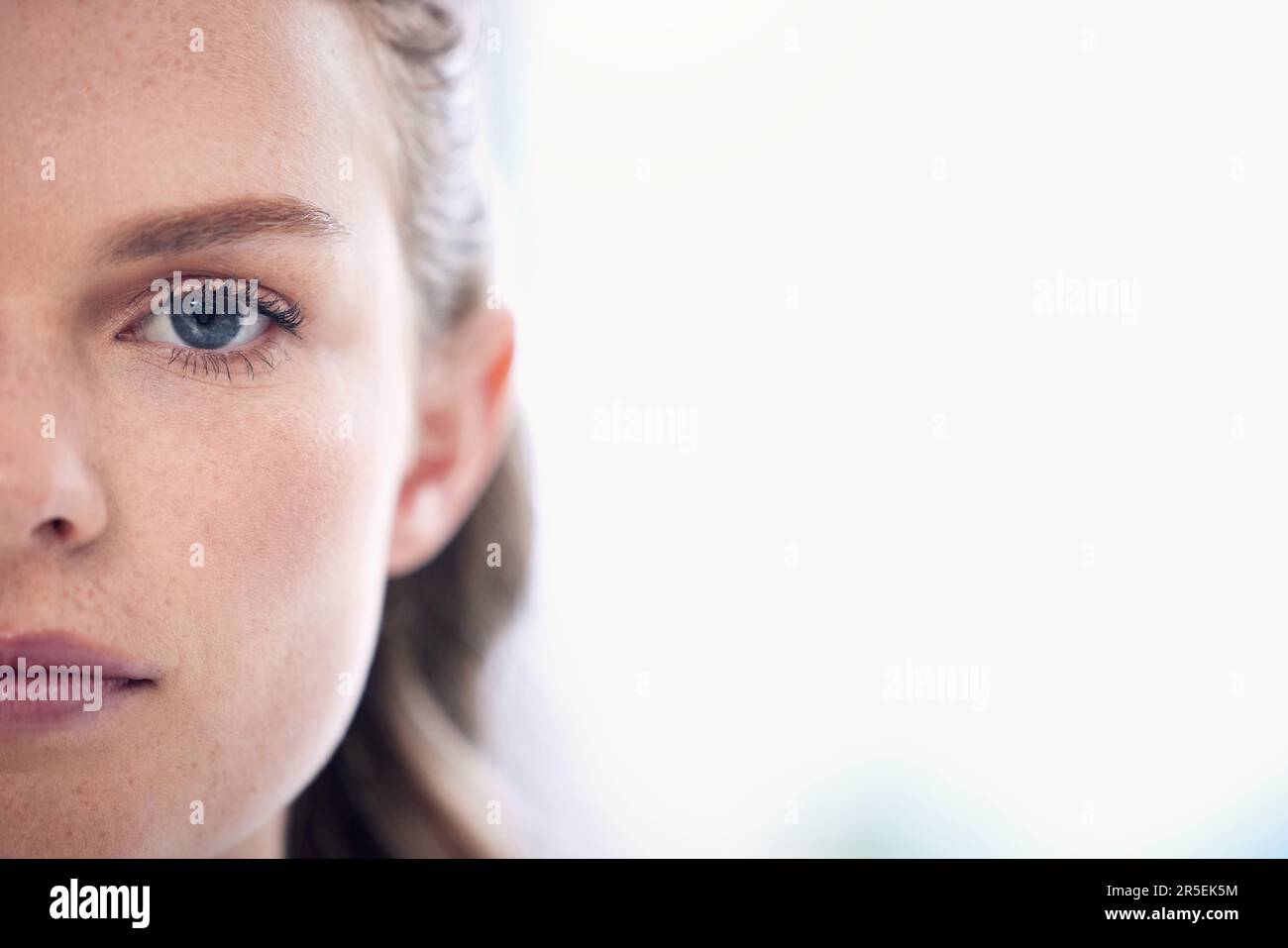 Woman, focus and half face with a healthy vision for awareness in ...