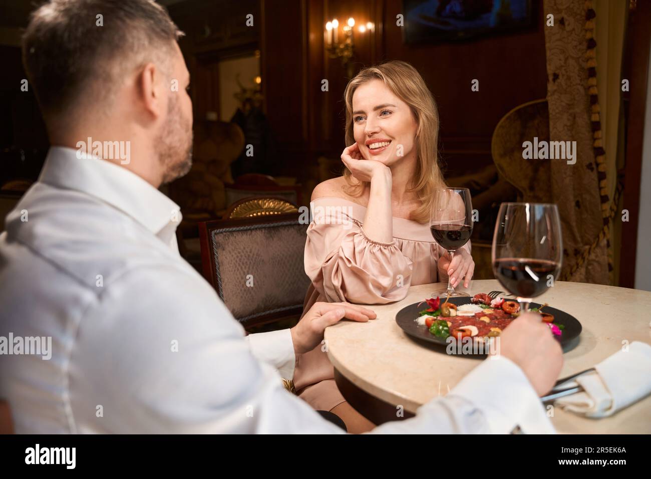 Happy lovely couple having romantic dinner in the luxury restaurant ...