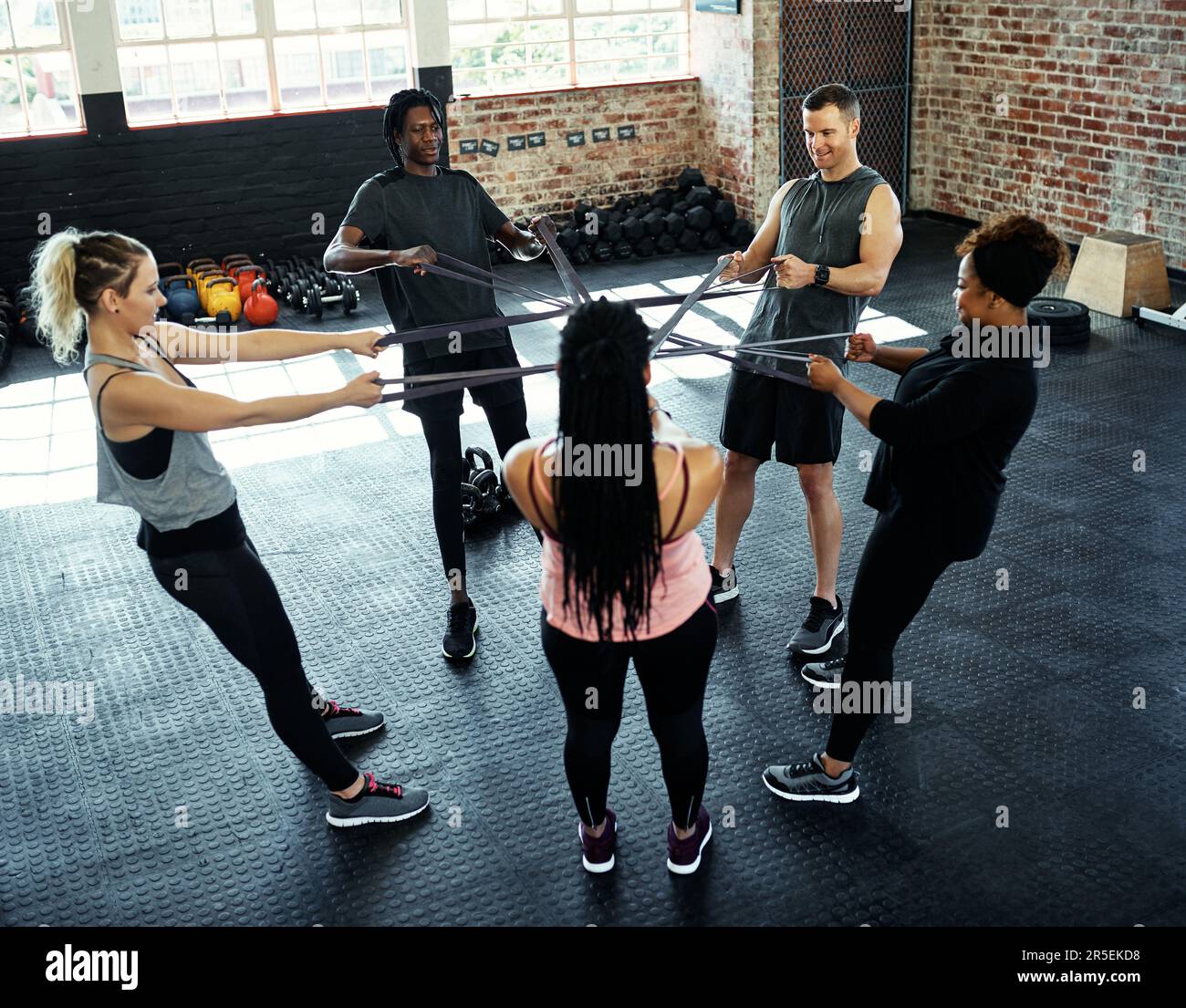 Switching things up. a fitness group working out with resistance bands ...