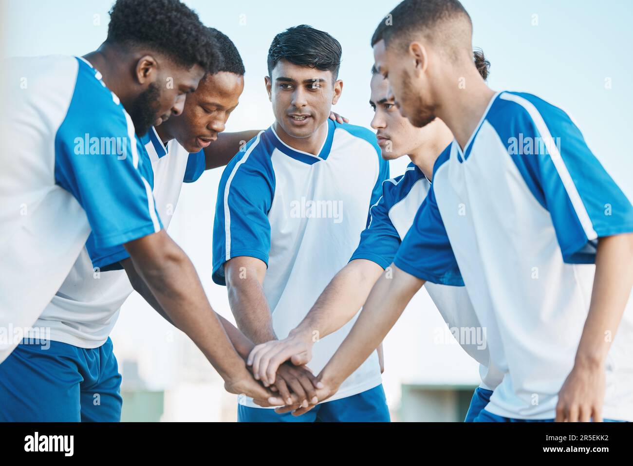 Hands together, sports group and soccer team on field for fitness ...