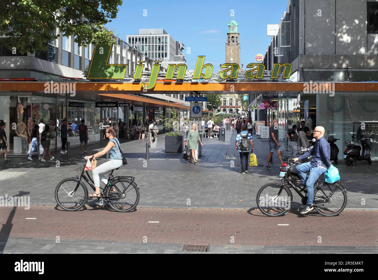 Cyclists on a bike lane passing the Lijnbaan shopping precinct in ...