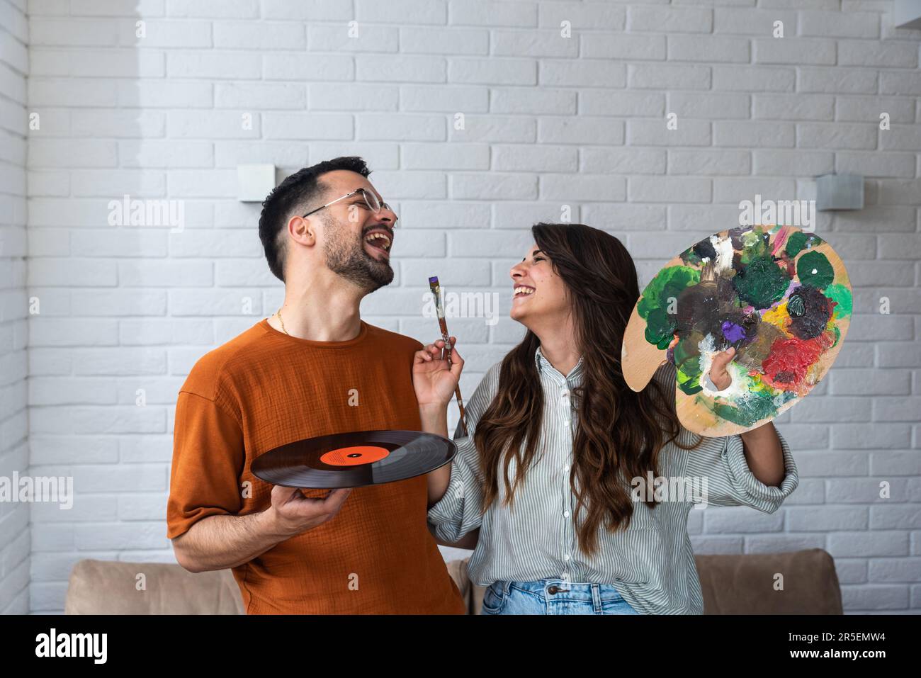 Creative couple painting on canvas in art studio. Modern artwork paint ...