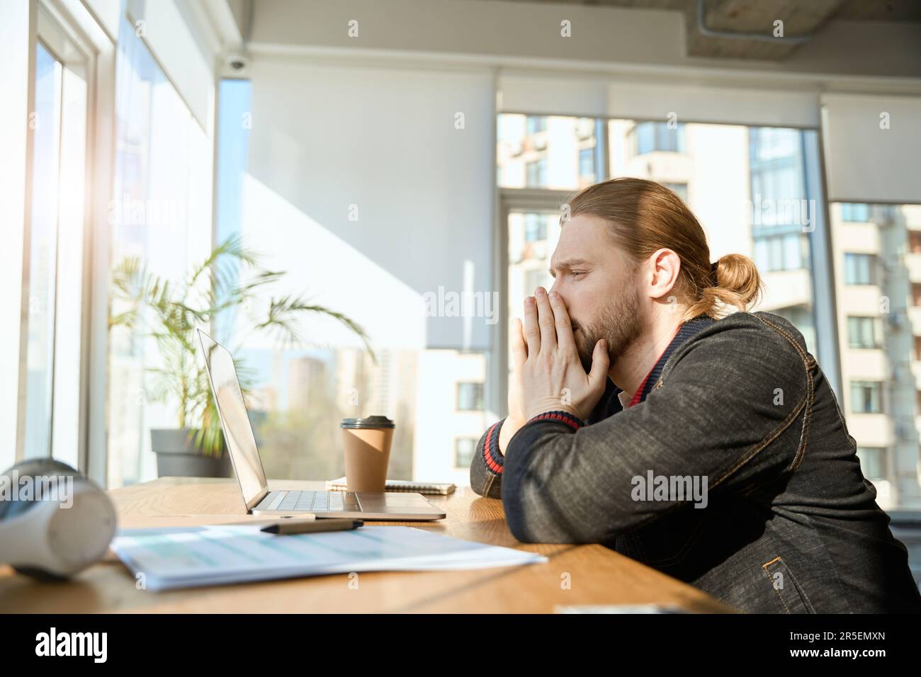 Handsome man doing work tasks at his workplace Stock Photo - Alamy