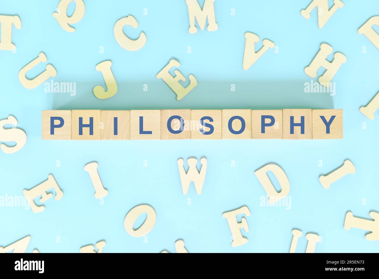 Philosophy concept. Word spelled in wooden blocks on blue background ...