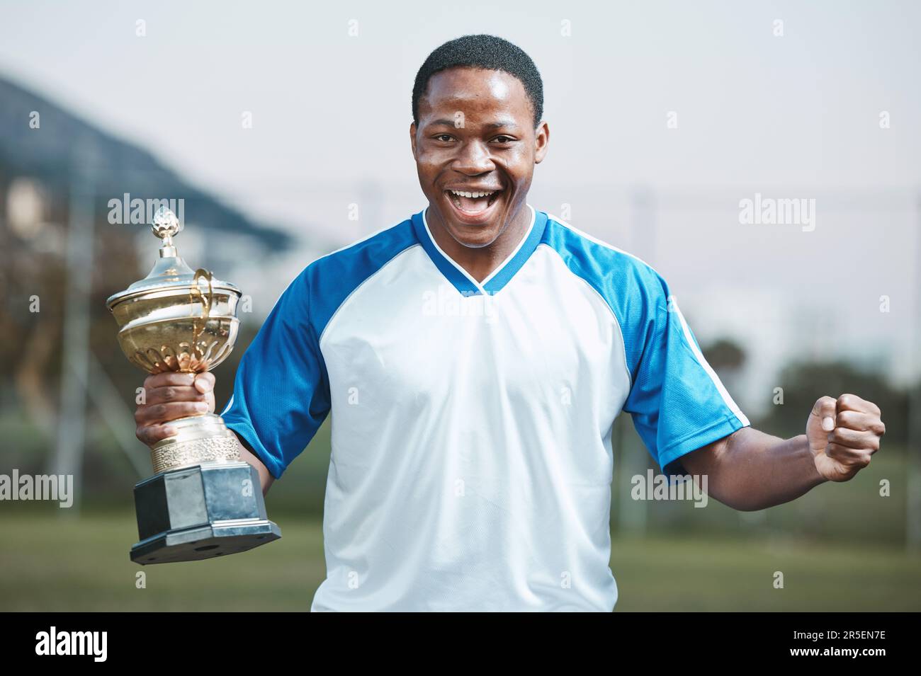 Sports, soccer player and man celebrate trophy for competition or game ...