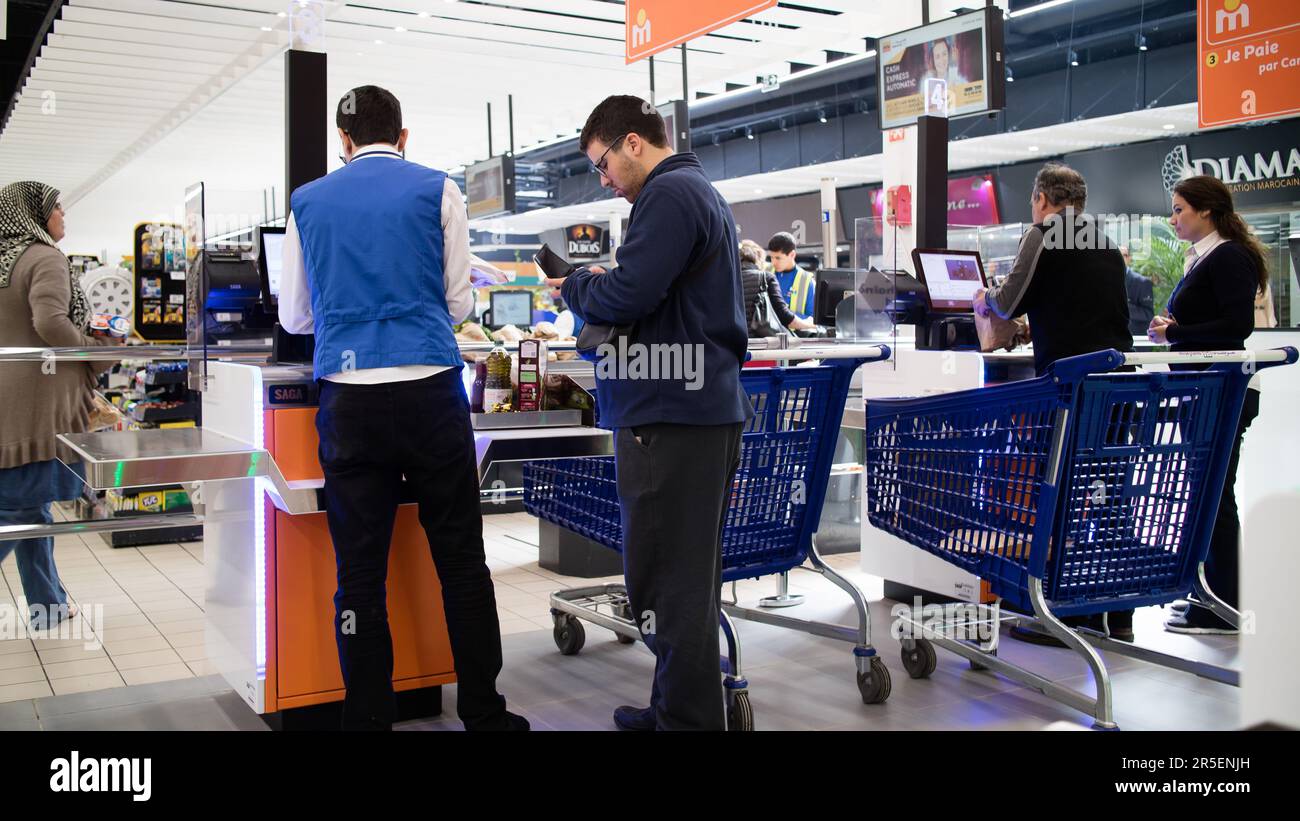 Customers Receiving Assistance at Self-checkout in Supermarket Stock ...