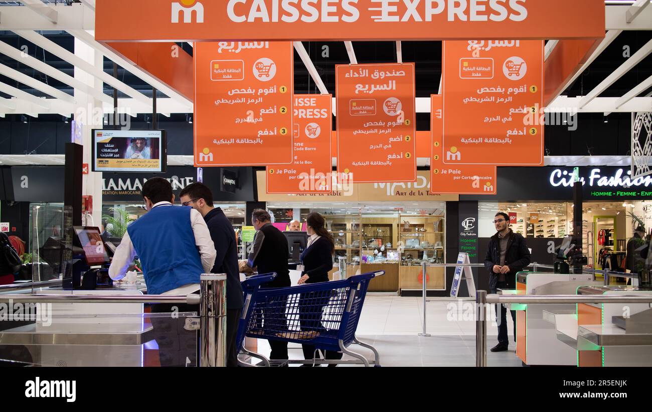 Supermarket Personnel Guide Customers through Self-checkout Stock Photo ...