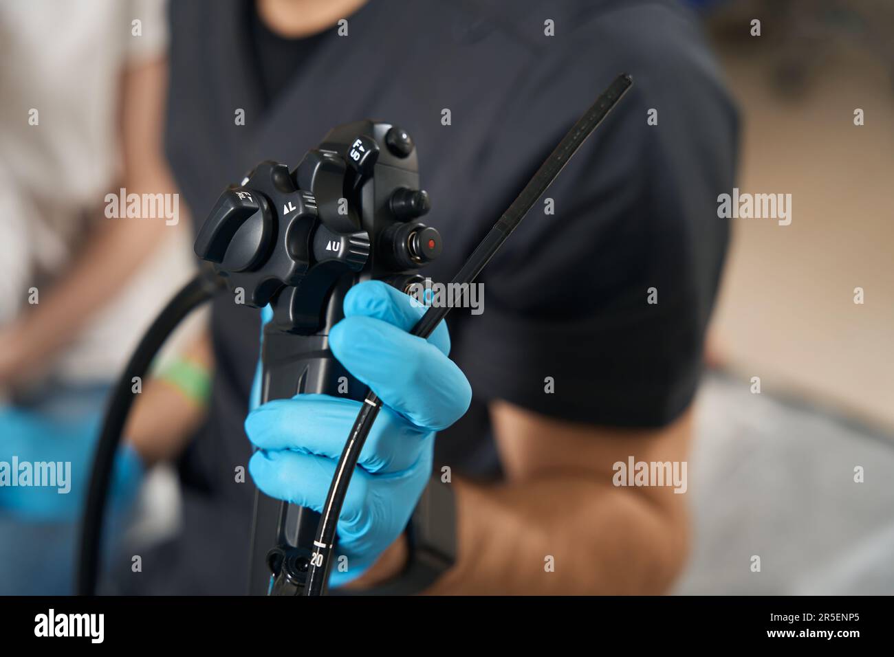 Professional endoscopist showing endoscopic equipment to patient Stock ...