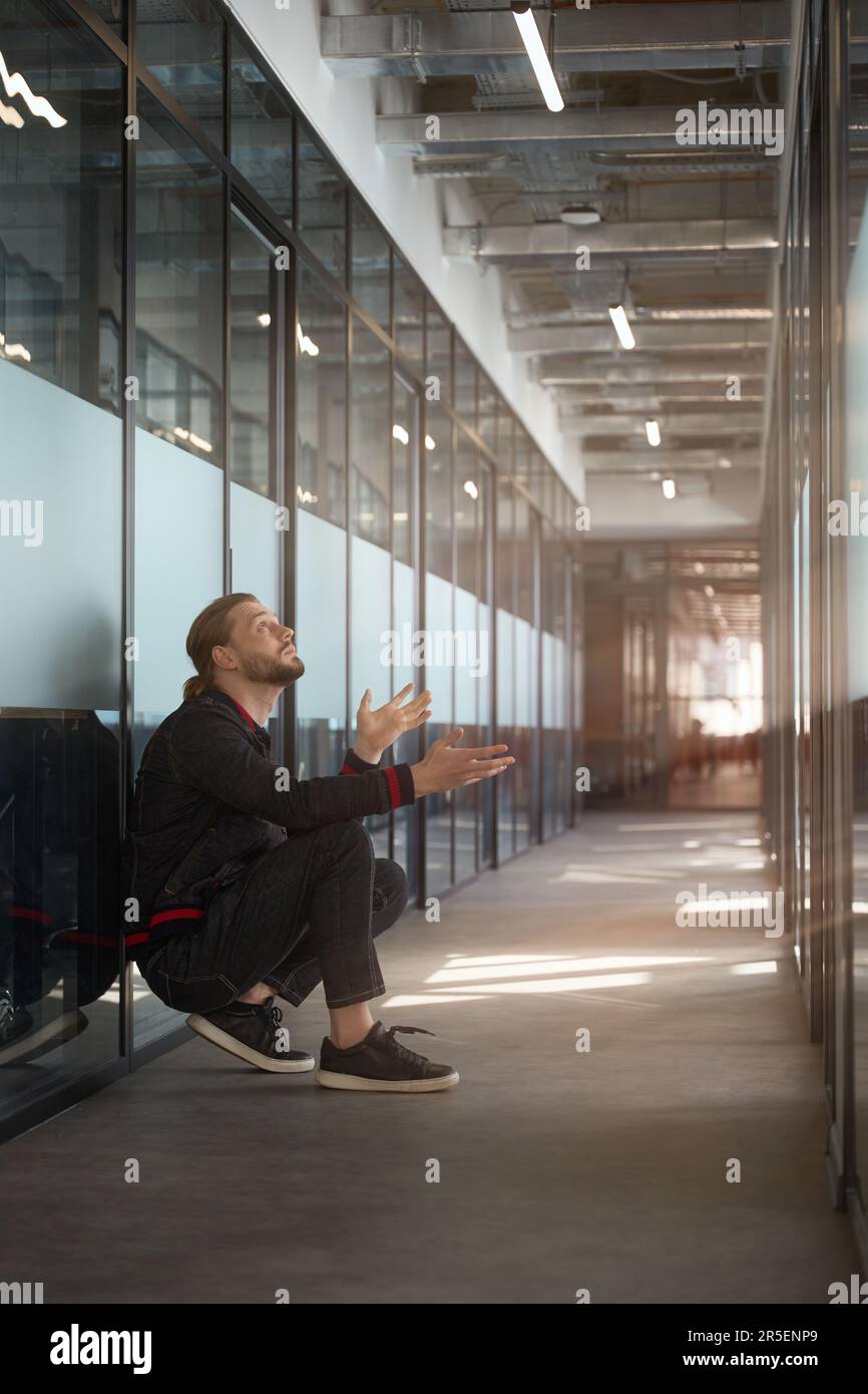 Young man looking at ceiling in hallway Stock Photo - Alamy