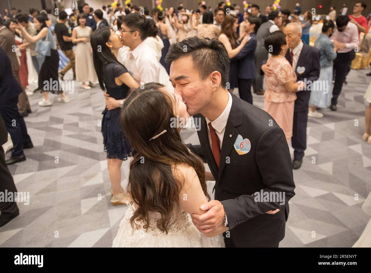 Newly marriages couples attend a group wedding ceremony hold by Taipei ...