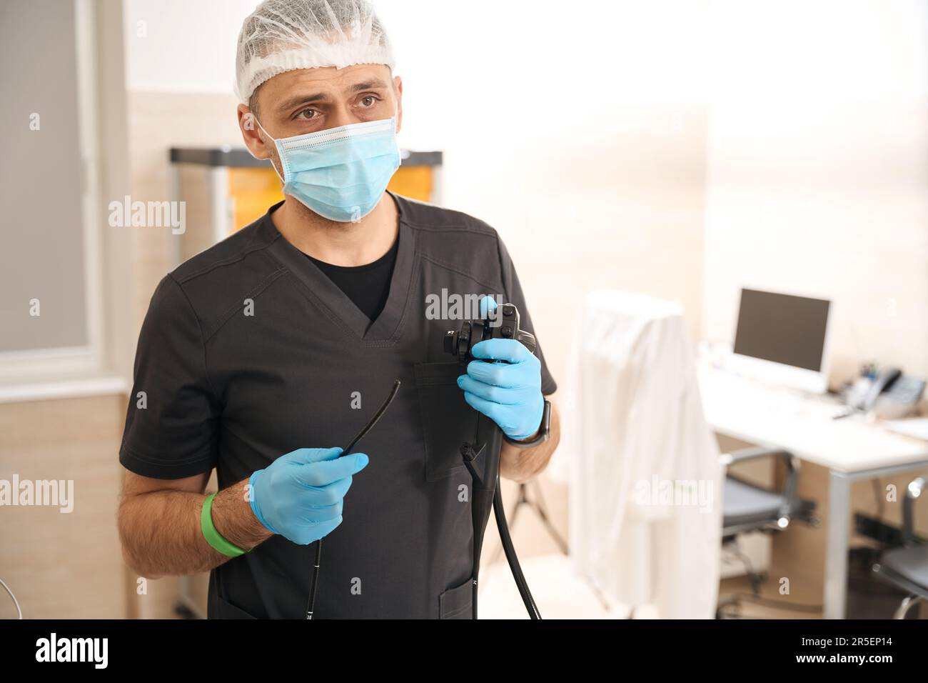 Serious endoscopist with endoscopic device in procedure room Stock ...