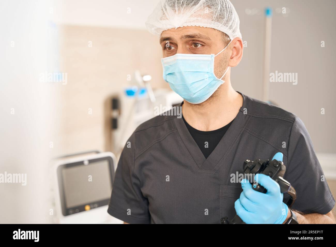 Male diagnostician with endoscopy instrument in clinic Stock Photo - Alamy
