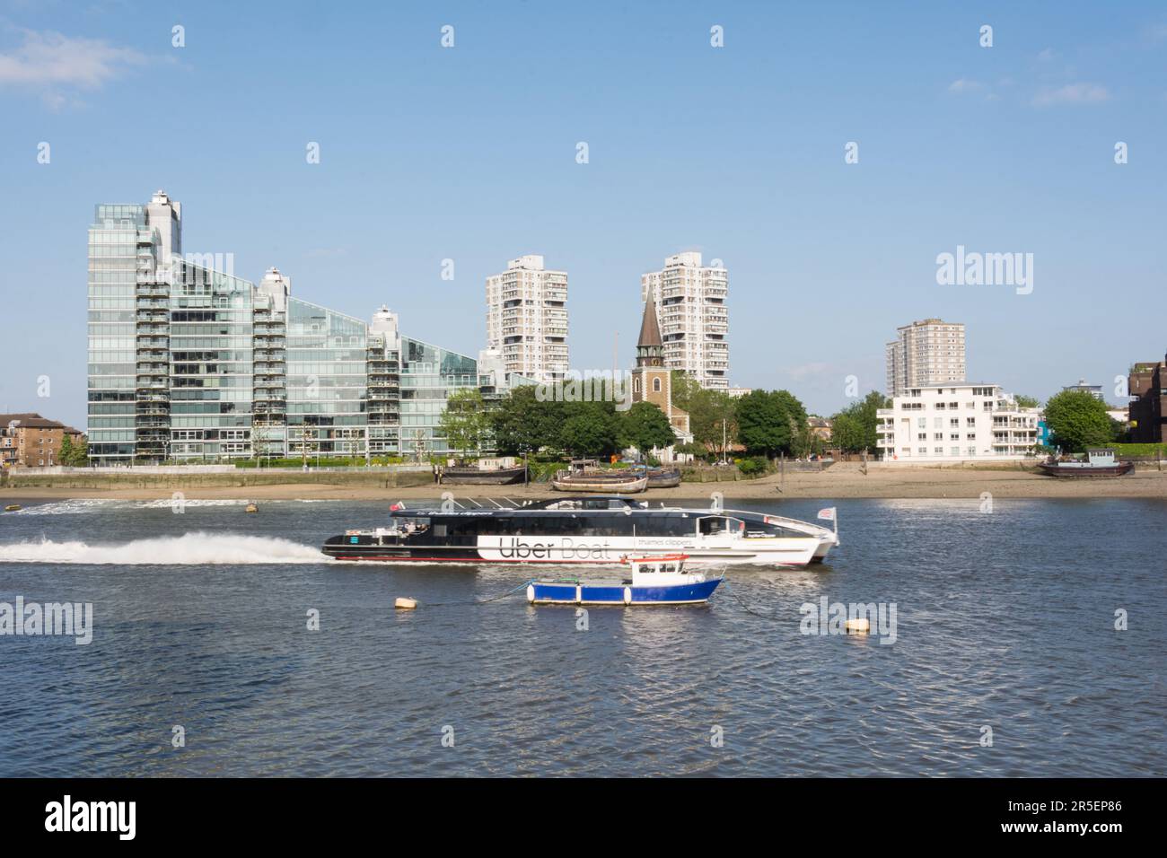 An Uber Boat on the River Thames and St Mary's Church, Battersea Church ...