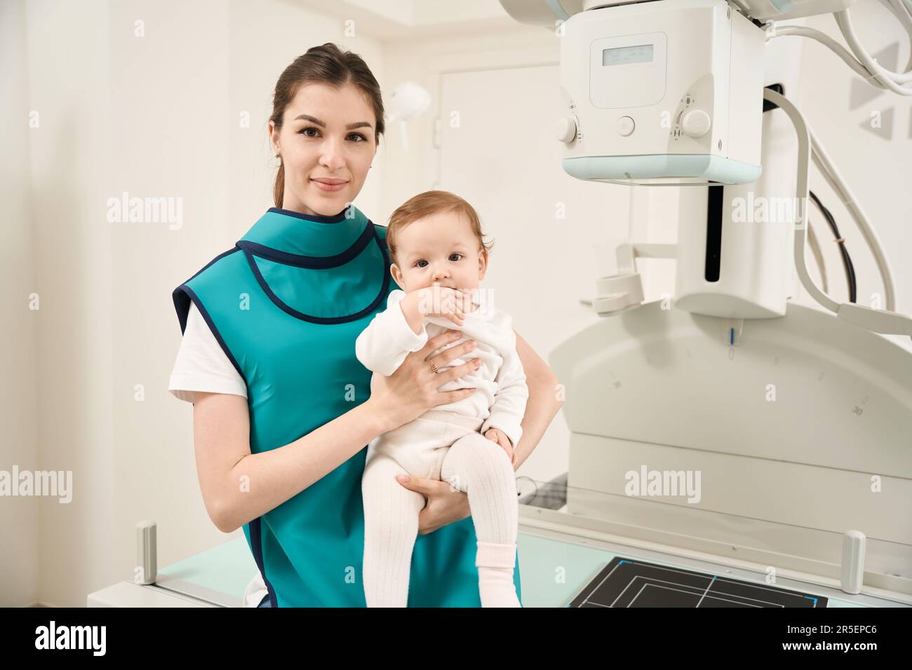 Young mother and her little child in radiography room Stock Photo - Alamy