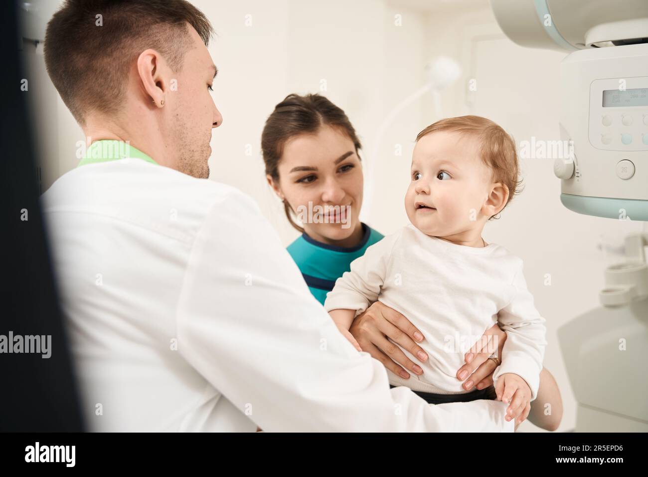 Radiologist getting infant ready for radiography procedure Stock Photo ...