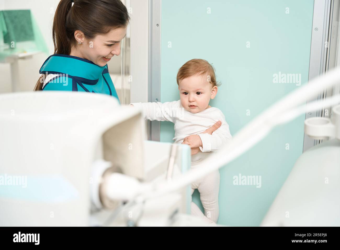 Little baby undergoing radiography procedure in presence of mother ...