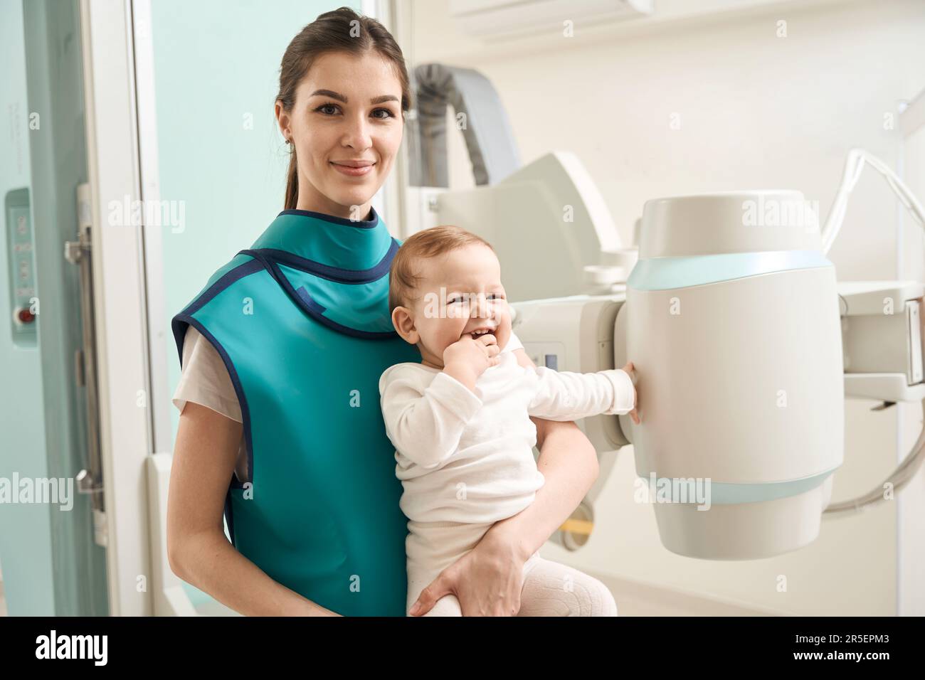 Smiling woman with her baby before radiography procedure Stock Photo ...