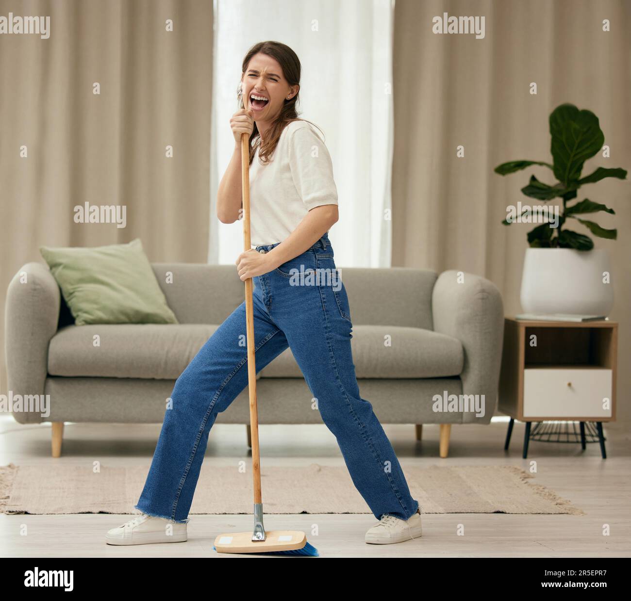 Woman, singing and broom to clean living room with funny dance ...