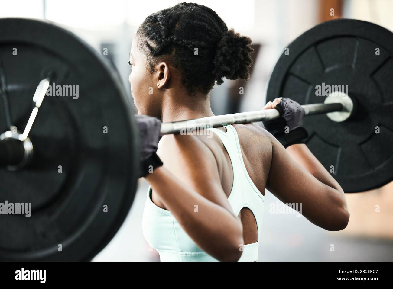 Black woman, back with weightlifting and fitness, barbell in gym and ...