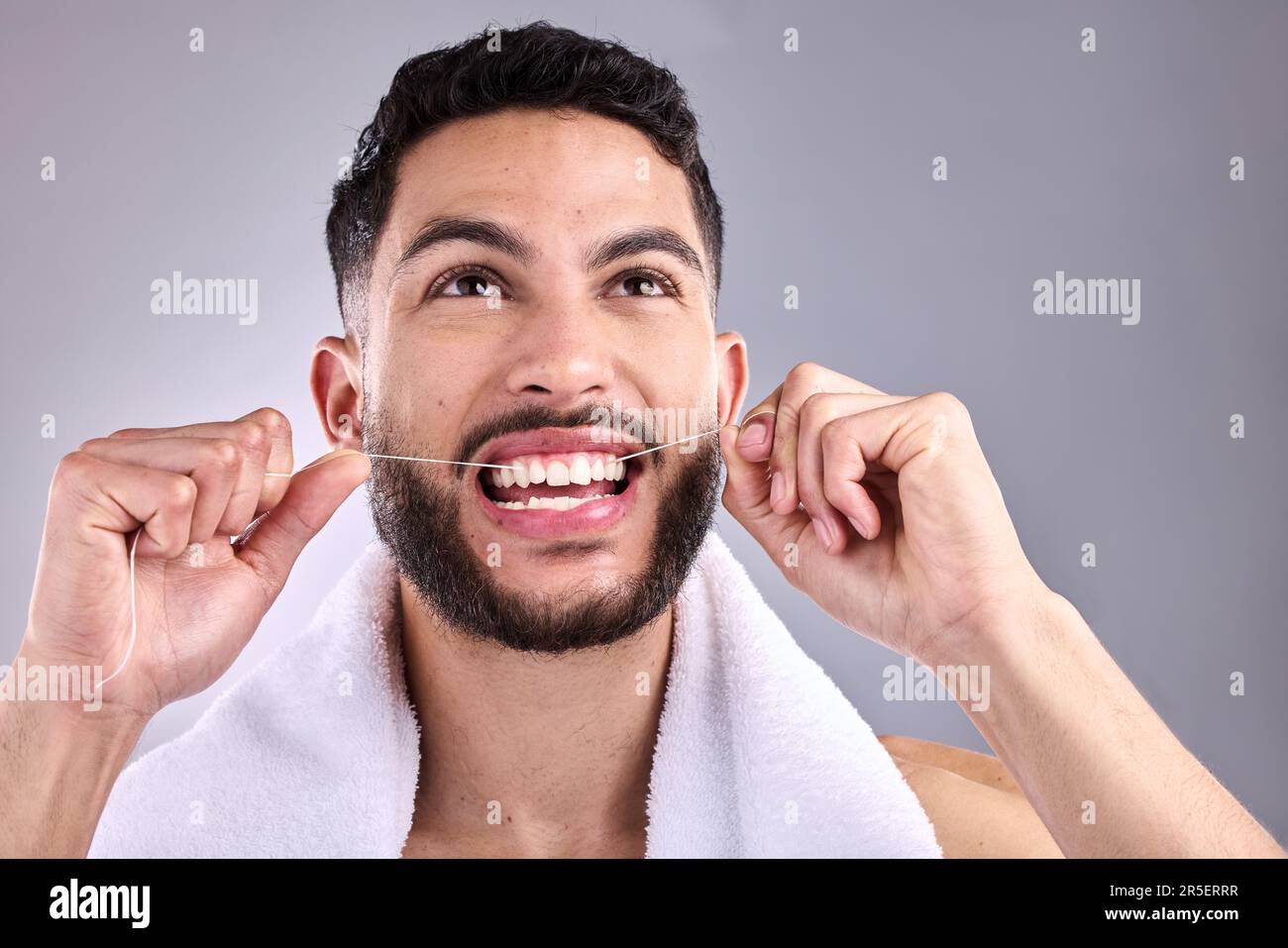 Face, man and floss teeth for dental health in studio isolated on a white background. Tooth ...