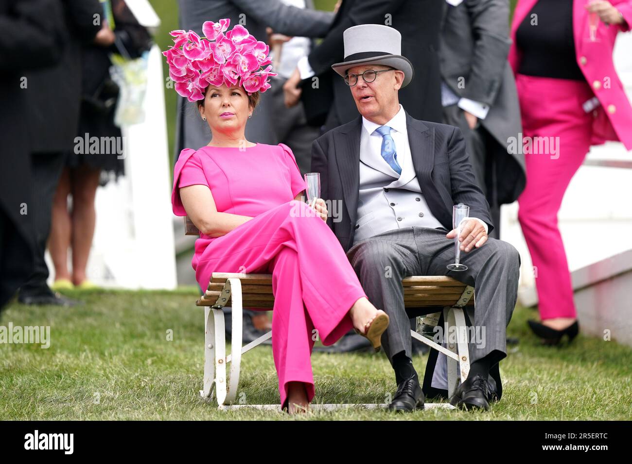 Spectators sit on a bench during Derby Day of the 2023 Derby Festival ...