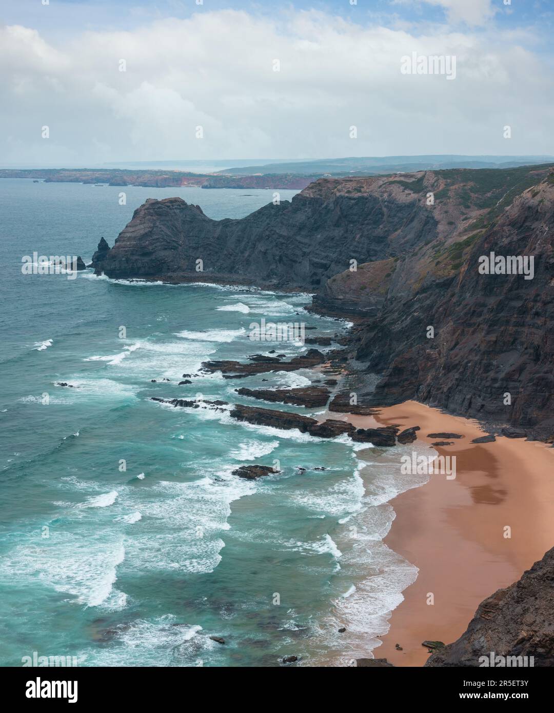 Sandy beach with stony ridges overcast weather view on summer Atlantic ...
