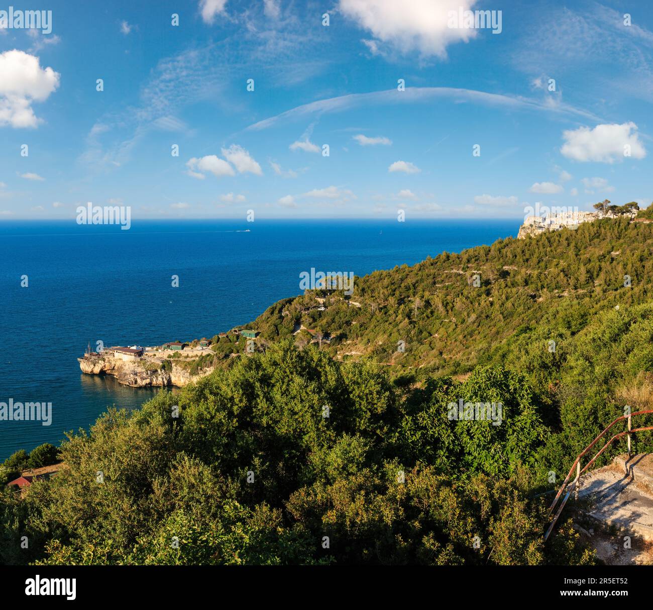 Summer sea perched Peschici town and cape Trabucco di Monte Pucci view ...