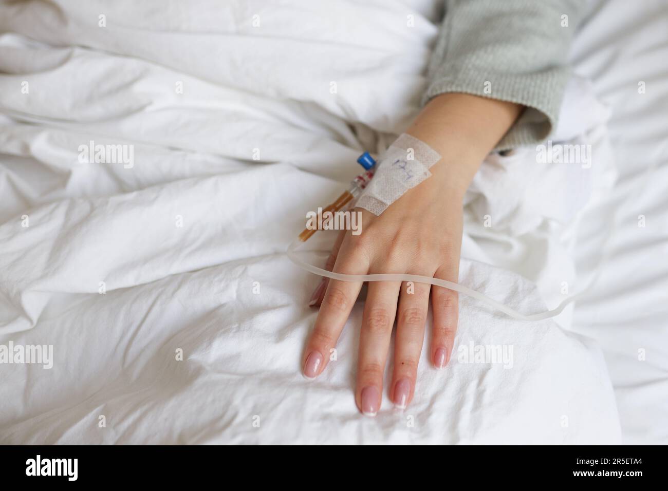 Drop of saline solution drip into patients arm in the hospital Stock ...