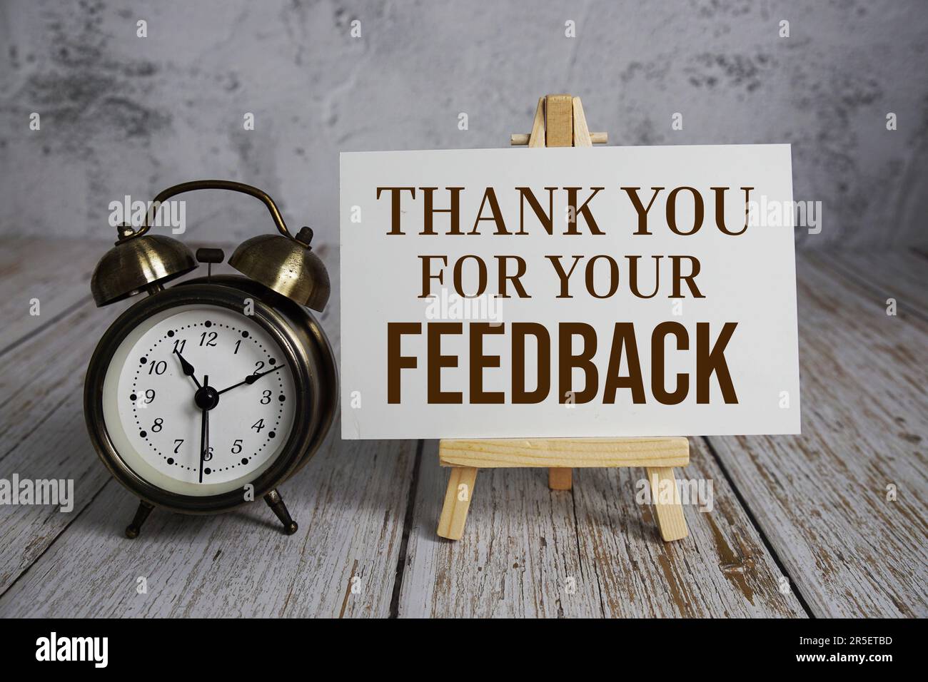 Thank you for your Feedback text message and alarm clock on wooden ...