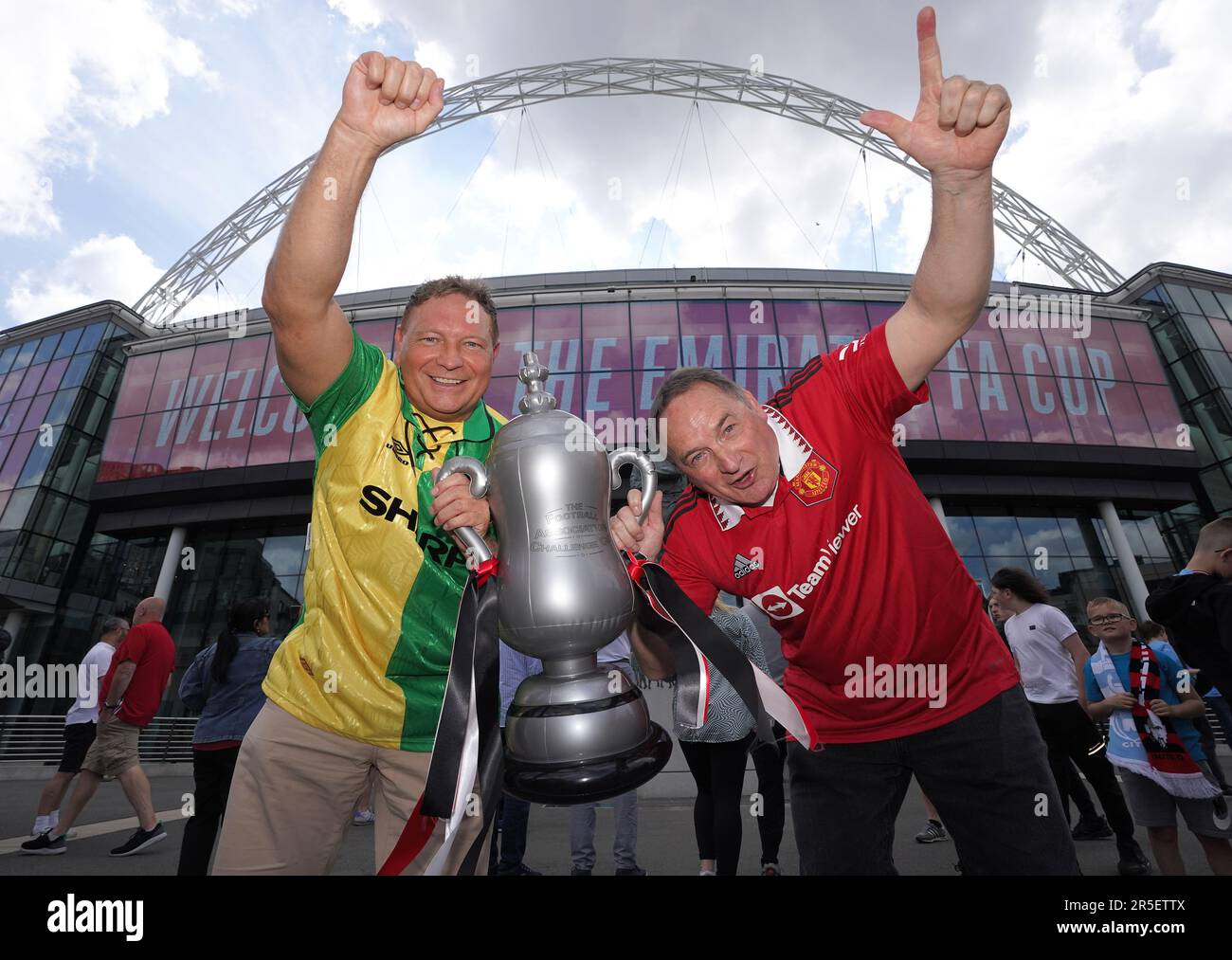 Manchester United fans with an inflatable trophy pose for a picture on ...