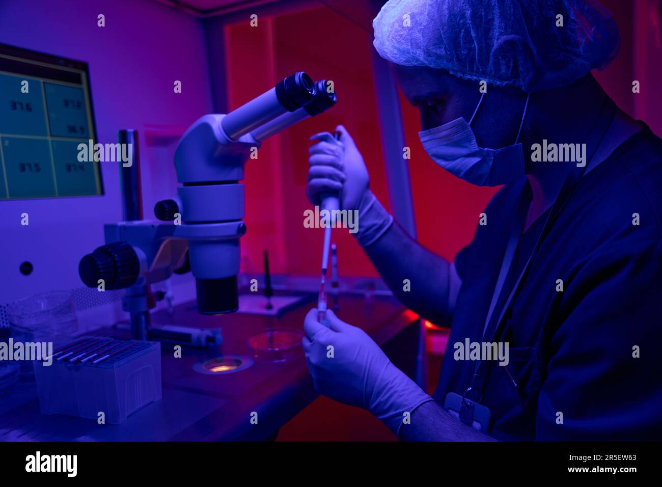 Genetic laboratory researcher taking sample from test tube in clinic ...