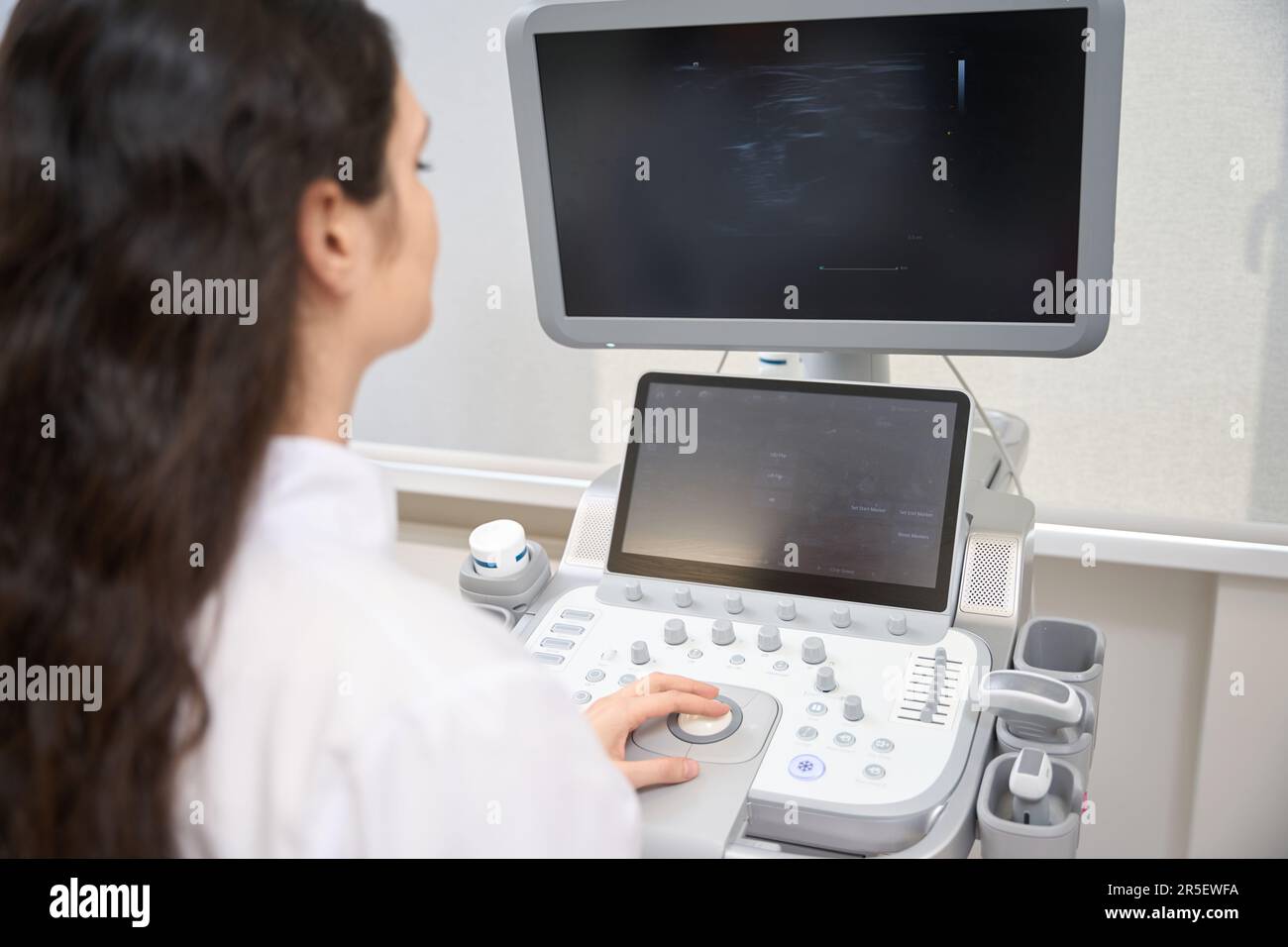 Female doctor working on equipment in the clinic Stock Photo - Alamy