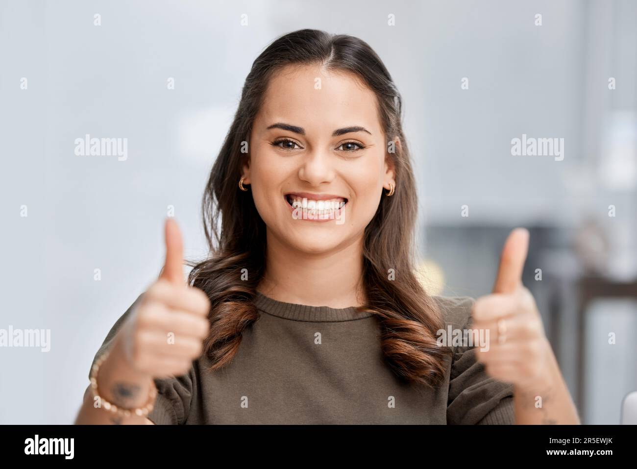 Thank you, portrait of woman with thumbs up and happy at her workplace ...