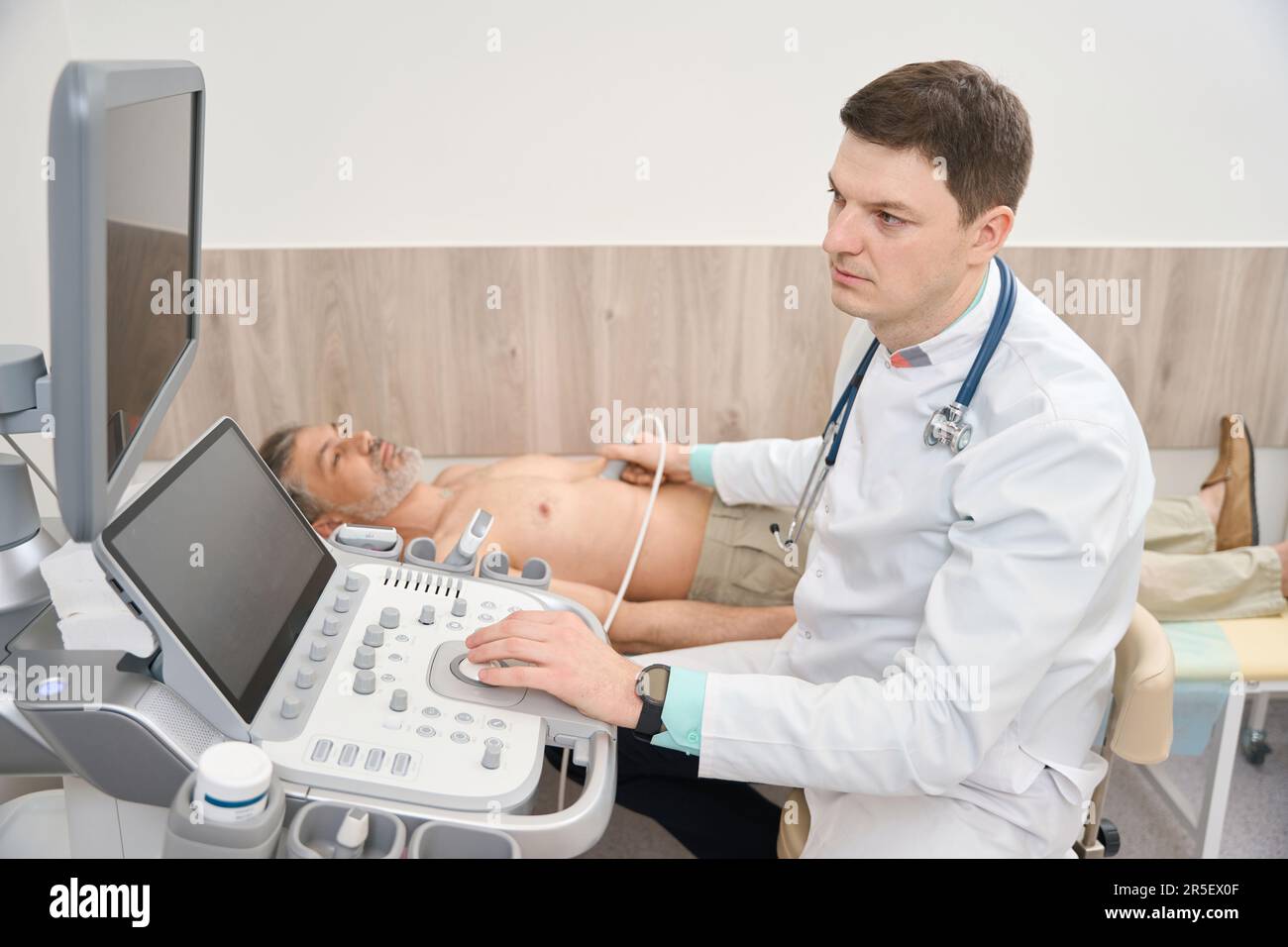 Doctor scanning internal organs of patient in the clinic Stock Photo ...