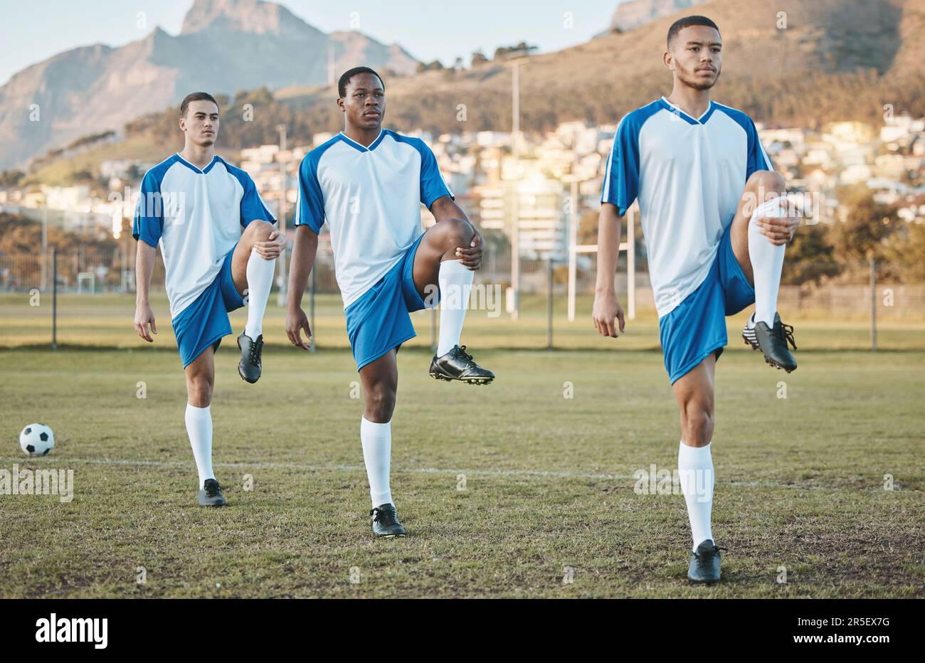 Soccer, sports and team stretching legs on a field for fitness ...