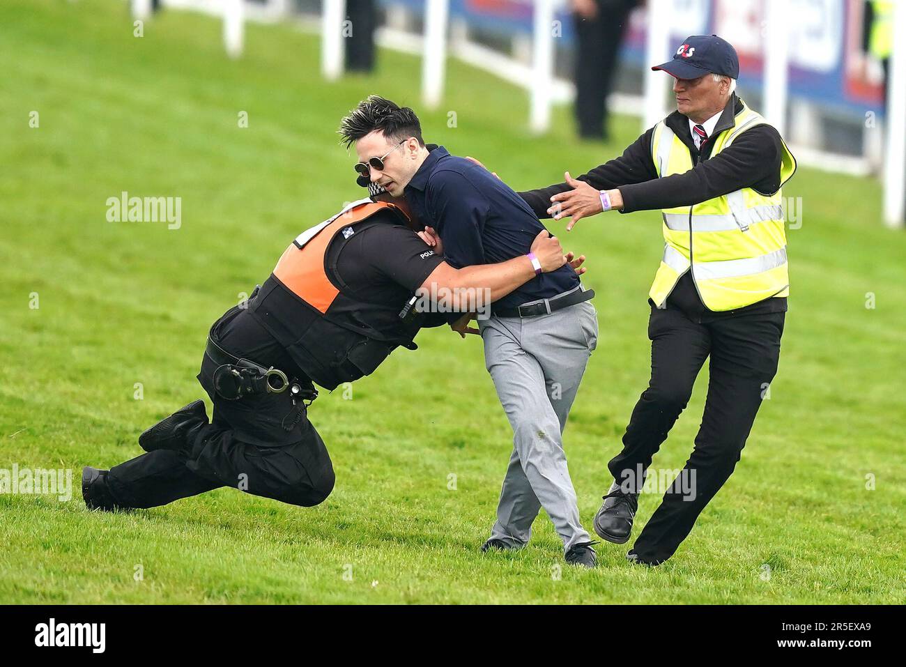 A protestor is tackled by police and stewards prior to the start of the ...