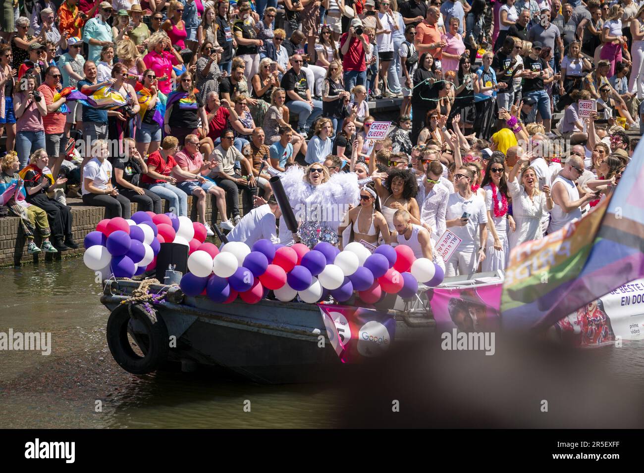 UTRECHT - Participants in the Utrecht Pride boat parade wave to ...
