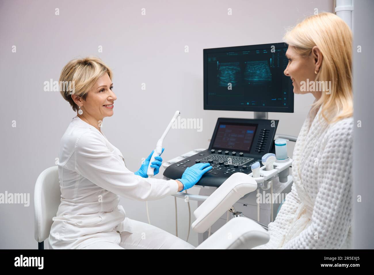 Gynecologist prepares patient for examination using vaginal ultrasound ...