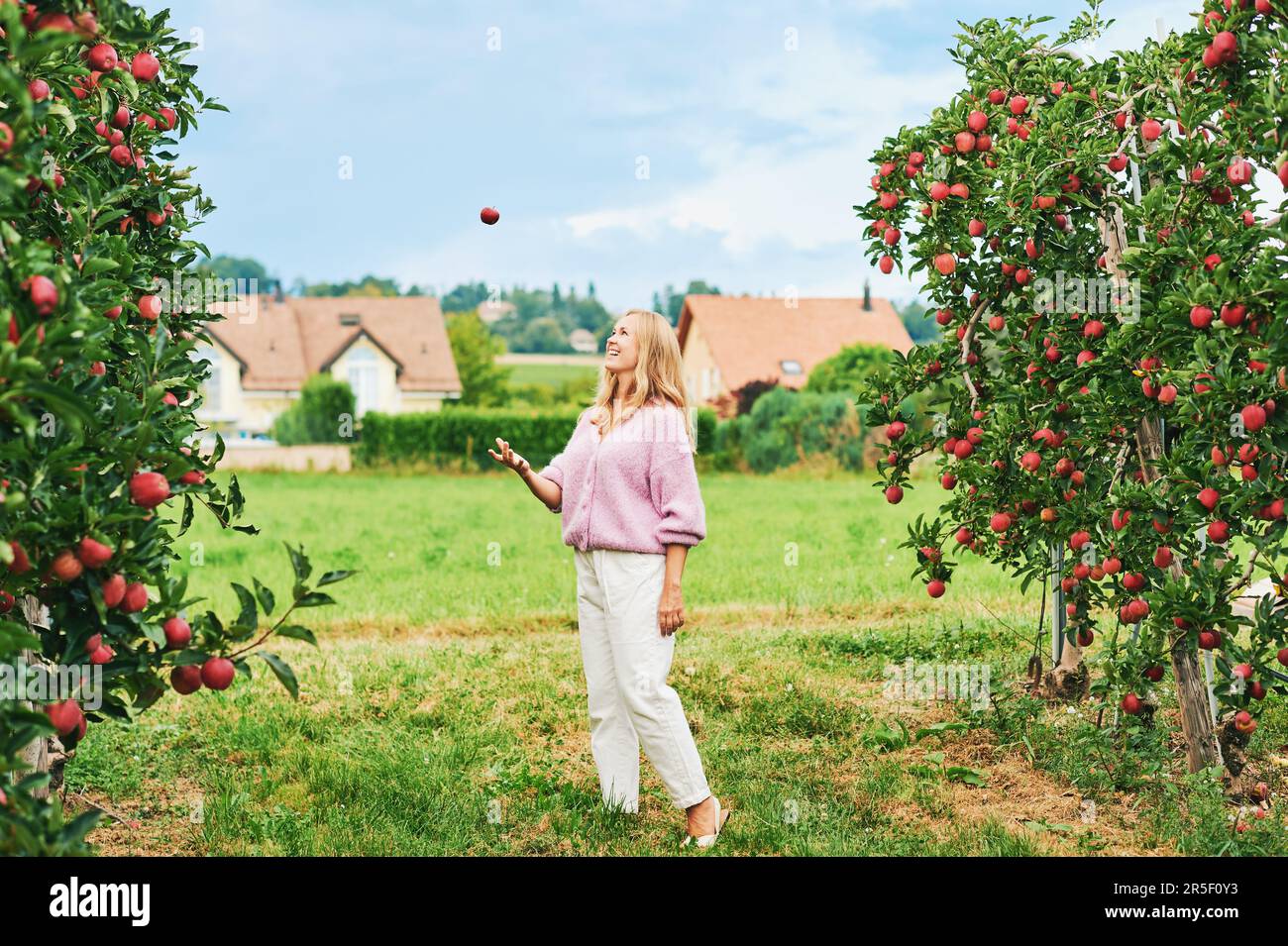 Outdoor portrait of happy young woman in countryside, female model ...