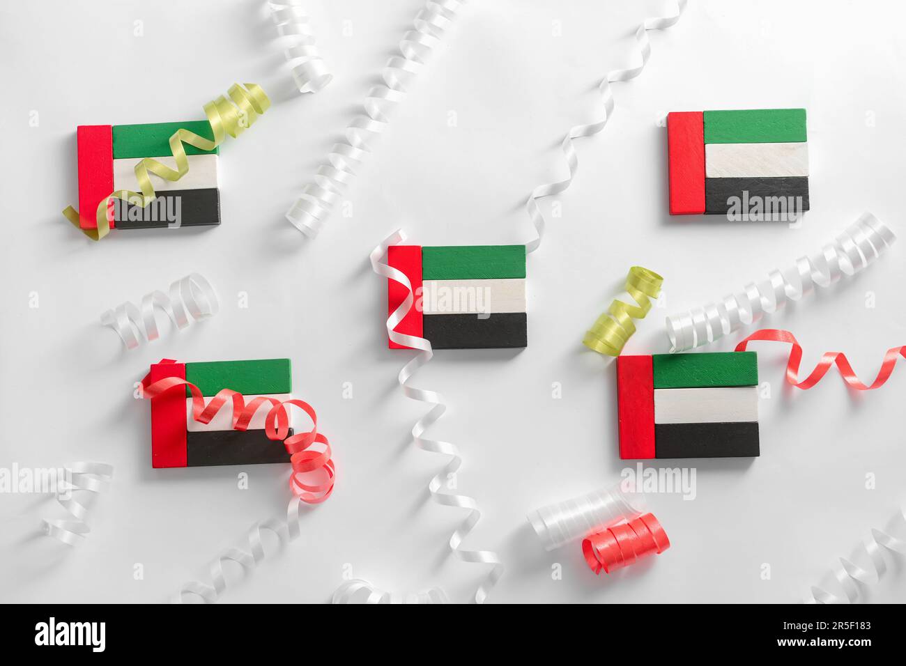 UAE flags made of blocks with ribbons on white background Stock Photo ...